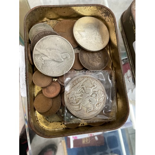 Old tobacco tin containing coins