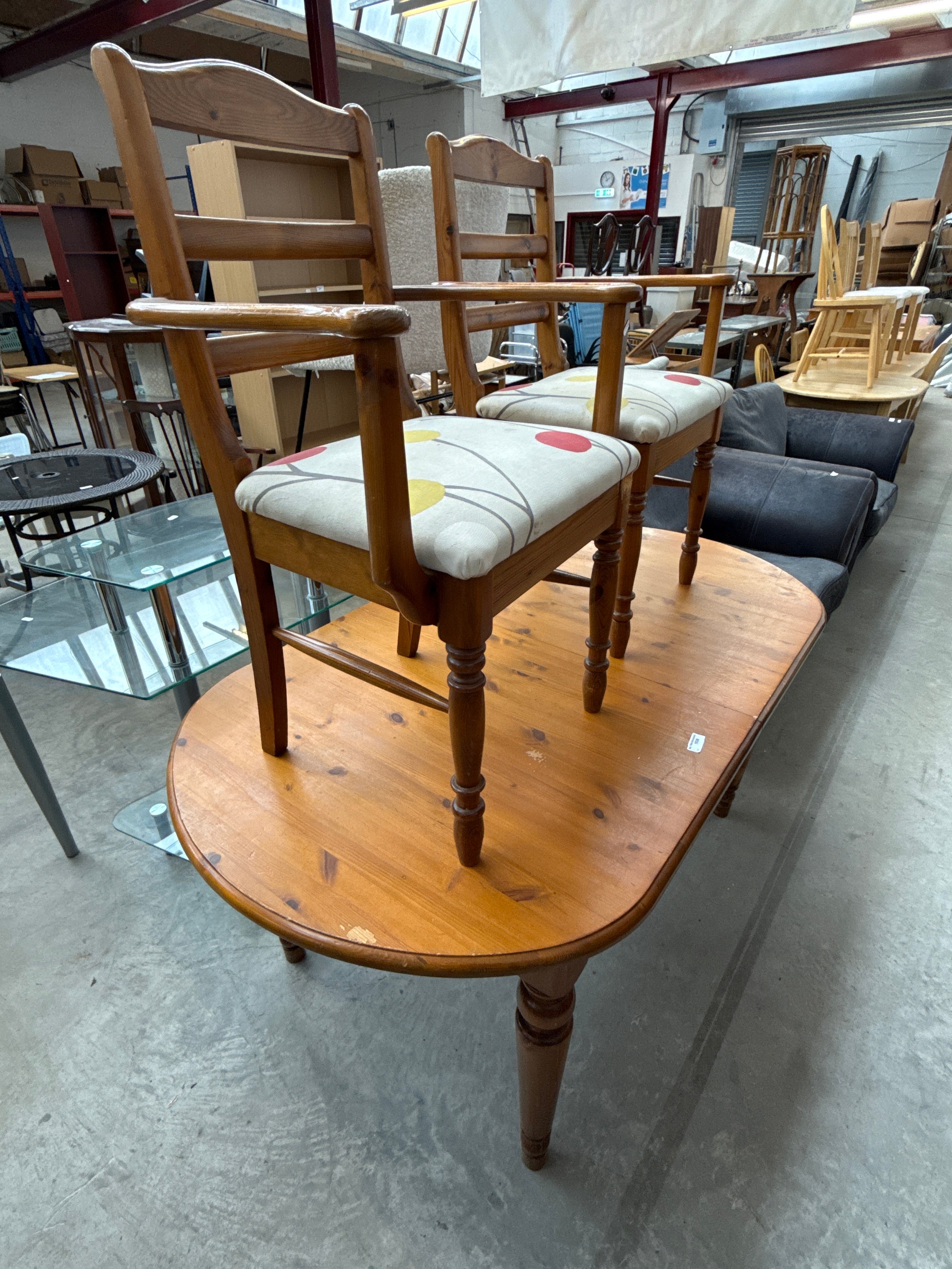 A large extending pine dining table and 2 x chairs