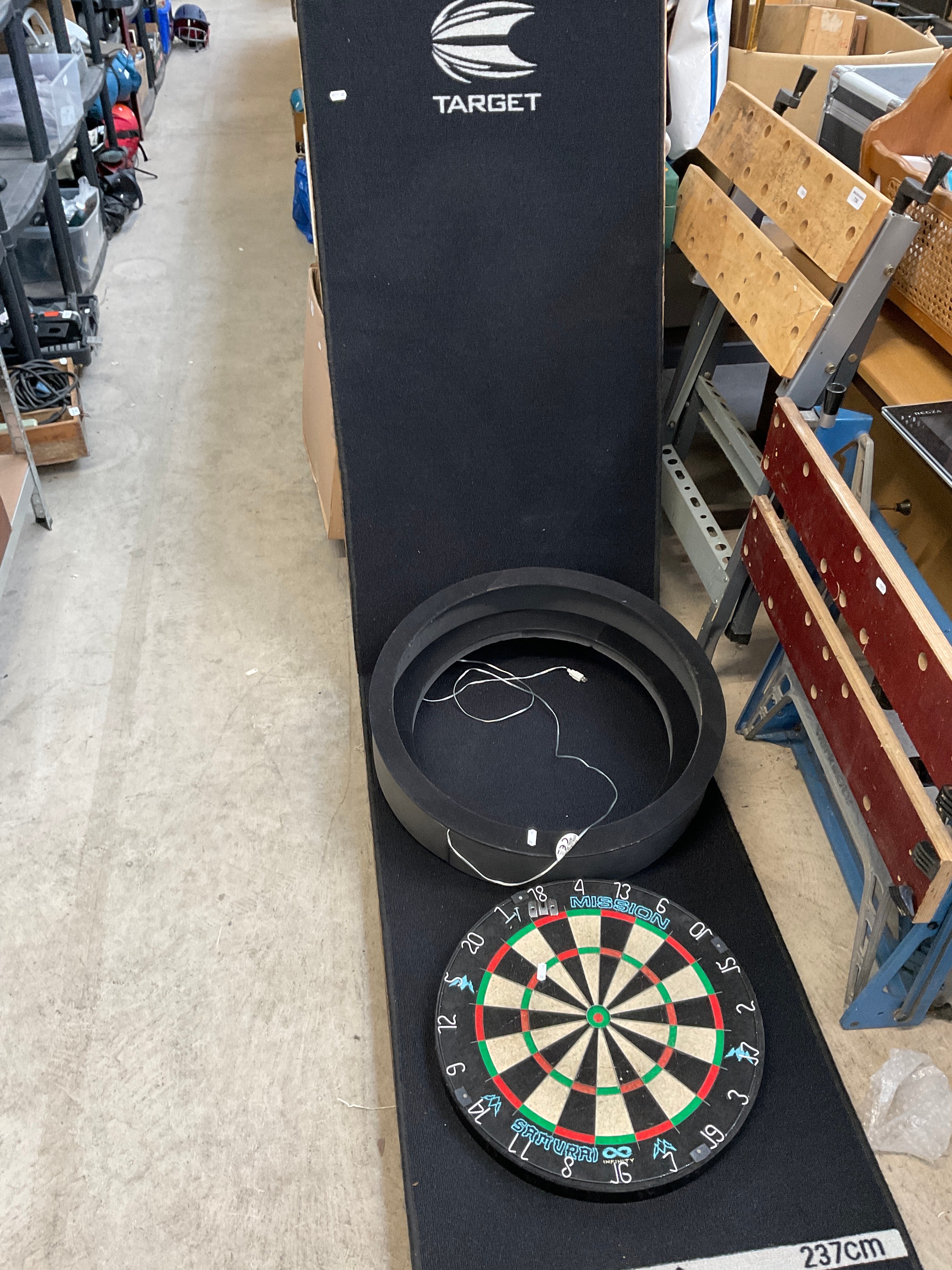 Folding darts oche, dartboard, and light