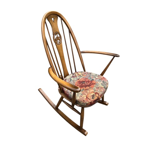 A QUALITY ERCOL OAK ROCKING CHAIR WITH SWAN TO CENTRE