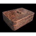 A CLASSY LEATHER COVERED BOX WITH ORNATE WORK AND MANS FACE