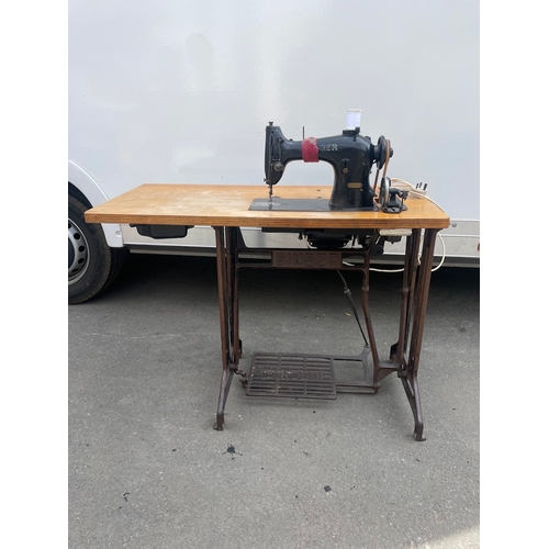Vintage Industrial Singer 95K40 sewing machine on iron table