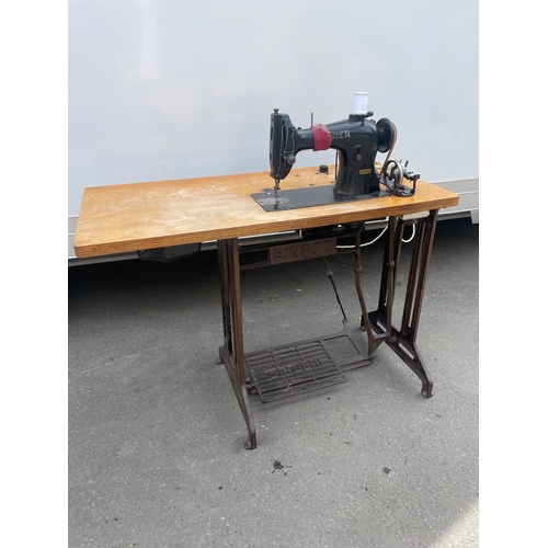 Vintage Industrial Singer 95K40 sewing machine on iron table
