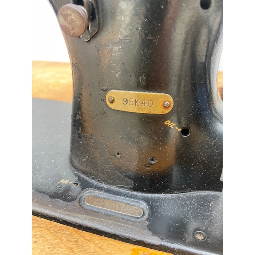 Vintage Industrial Singer 95K40 sewing machine on iron table