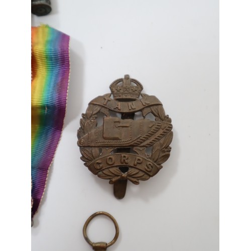 A collection of spent ammunition shells, two Cheshire Regiment Cap ...