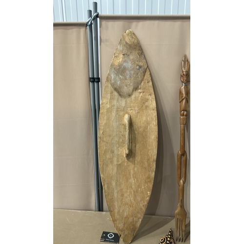 Carved wood African ceremonial shield featuring intricate animal motifs ...