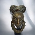 A tribal Benin / Bamun people bronze wall hanging mask.19 x 10cm
