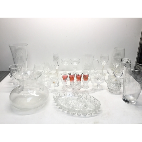 A large quantity of cut glass including vases and coloured glass