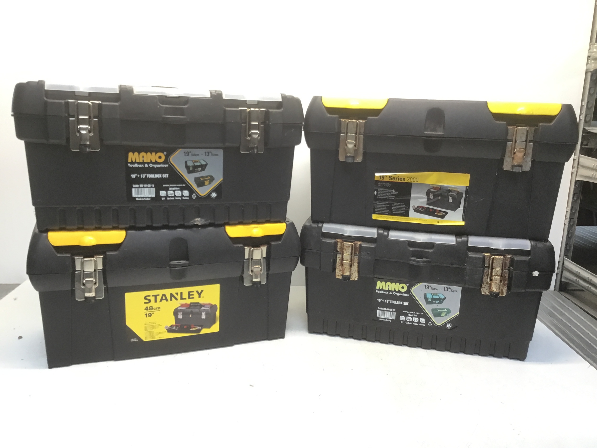Four empty plastic tool boxes