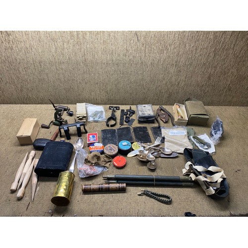 A collection of military equipment including pistol holsters, goggles ...