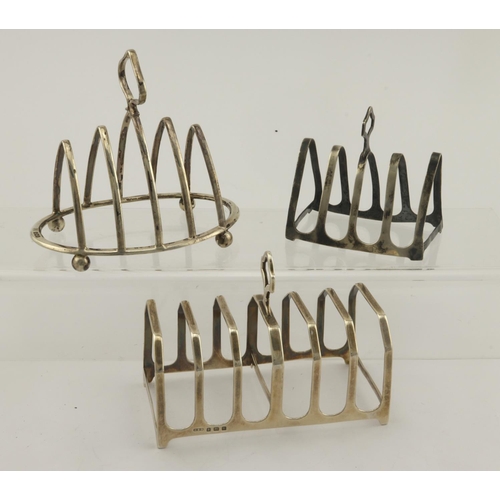 Three silver toast racks, two bear British hallmarks for Birm. 1920 and ...