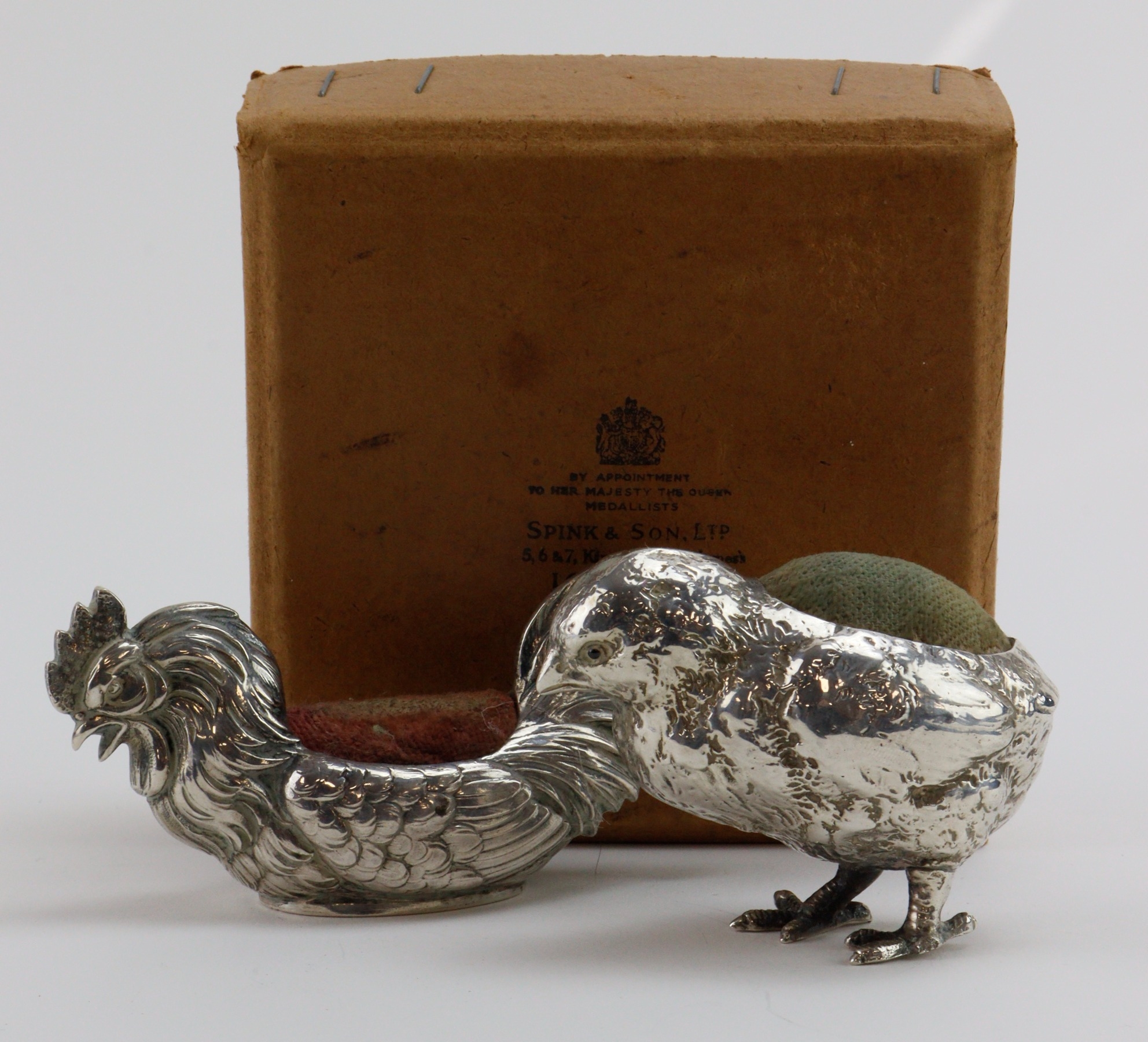 Pin Cushions. Two white metal novelty pin cushions depicting a cockerel ...