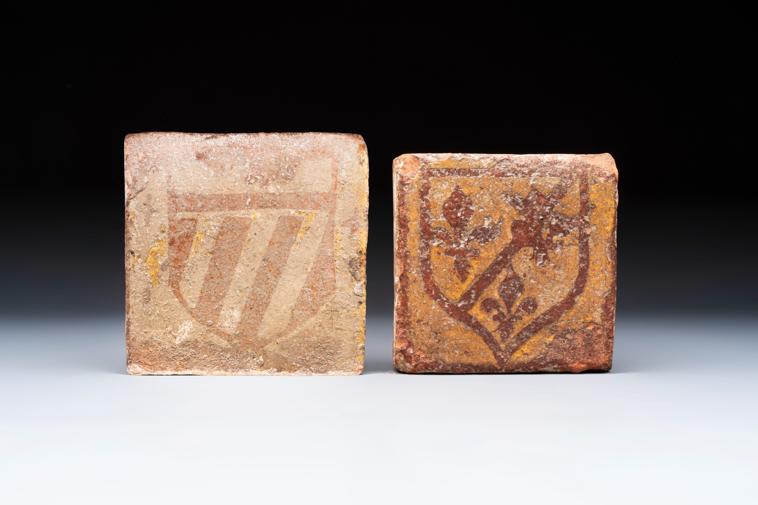 Two medieval slip-decorated tiles with the coat of arms of Burgundy and ...