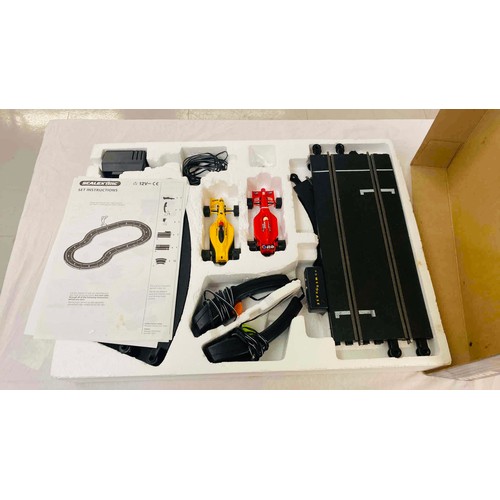 Scalextric Monaco slot car racing set features Minolta and Agip Formula ...