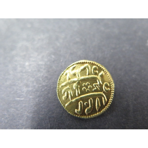 A Middle Eastern gold coin tested as 22ct with Arabic script, reverse ...