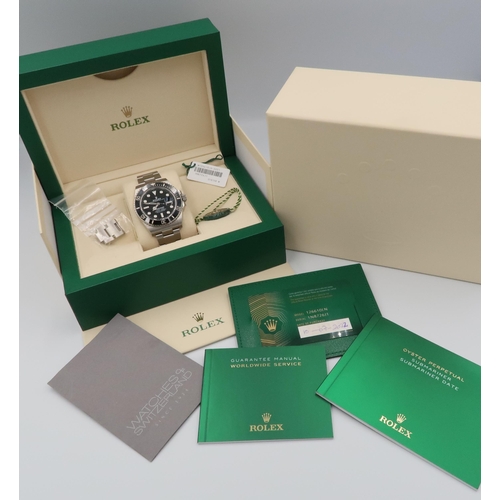 A Rolex Submariner watch, boxed with all paperwork, swing tag and ...