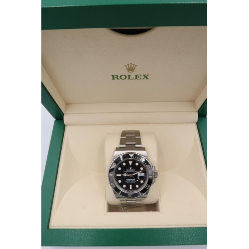 A Rolex Submariner watch, boxed with all paperwork, swing tag and ...