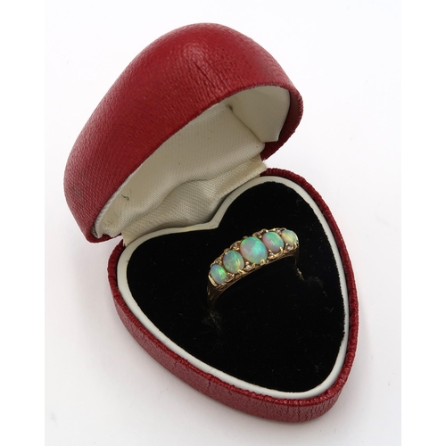 An 18ct gold, diamond and opal five stone ring, set with five opals, central stone of approximately