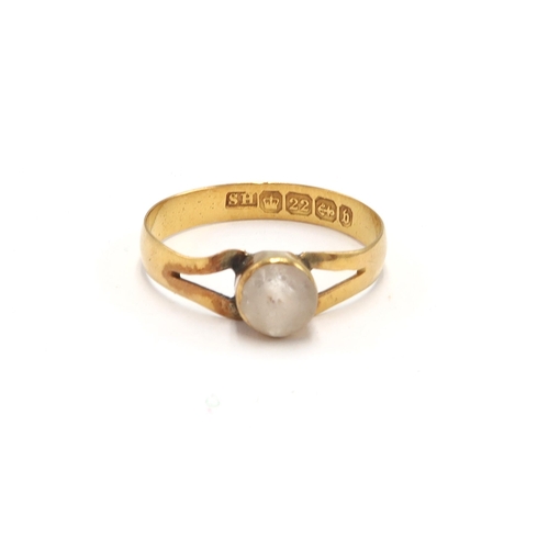 A 22ct gold and clear crystal set ring, the solitaire stone in collet ...