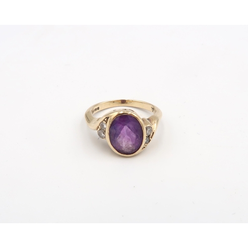 A 9ct gold amethyst and diamond crossover ring. Size L. Weight 4.44 grams
