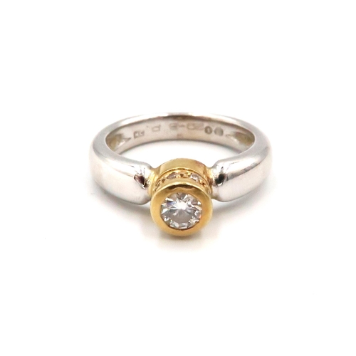 An 18ct white gold, gold and diamond ring, the solitaire stone in high ...