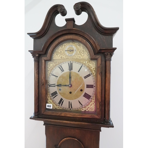 A 20th century longcase clock with a brass dial with pendulum and key ...
