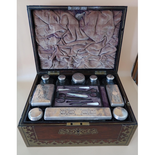 A George IV brass bound mahogany dressing table box, having perced and ...