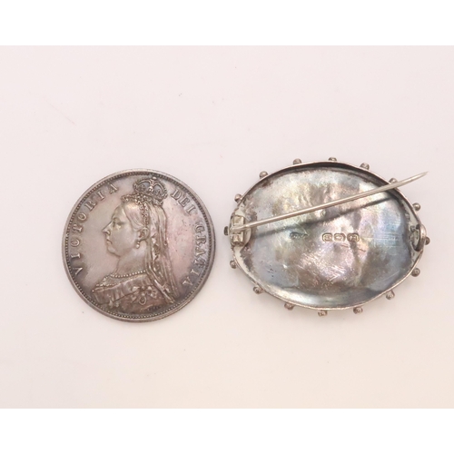 A Sterling Silver Queen Victoria Brooch 1887, along with an 1887 Half ...