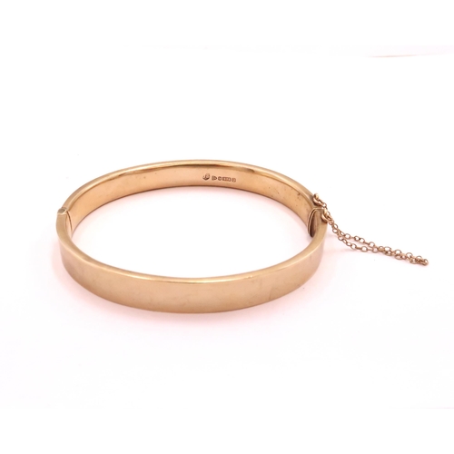 A 9ct Hollow Bangle, with scroll work design to outer facing edge, with ...