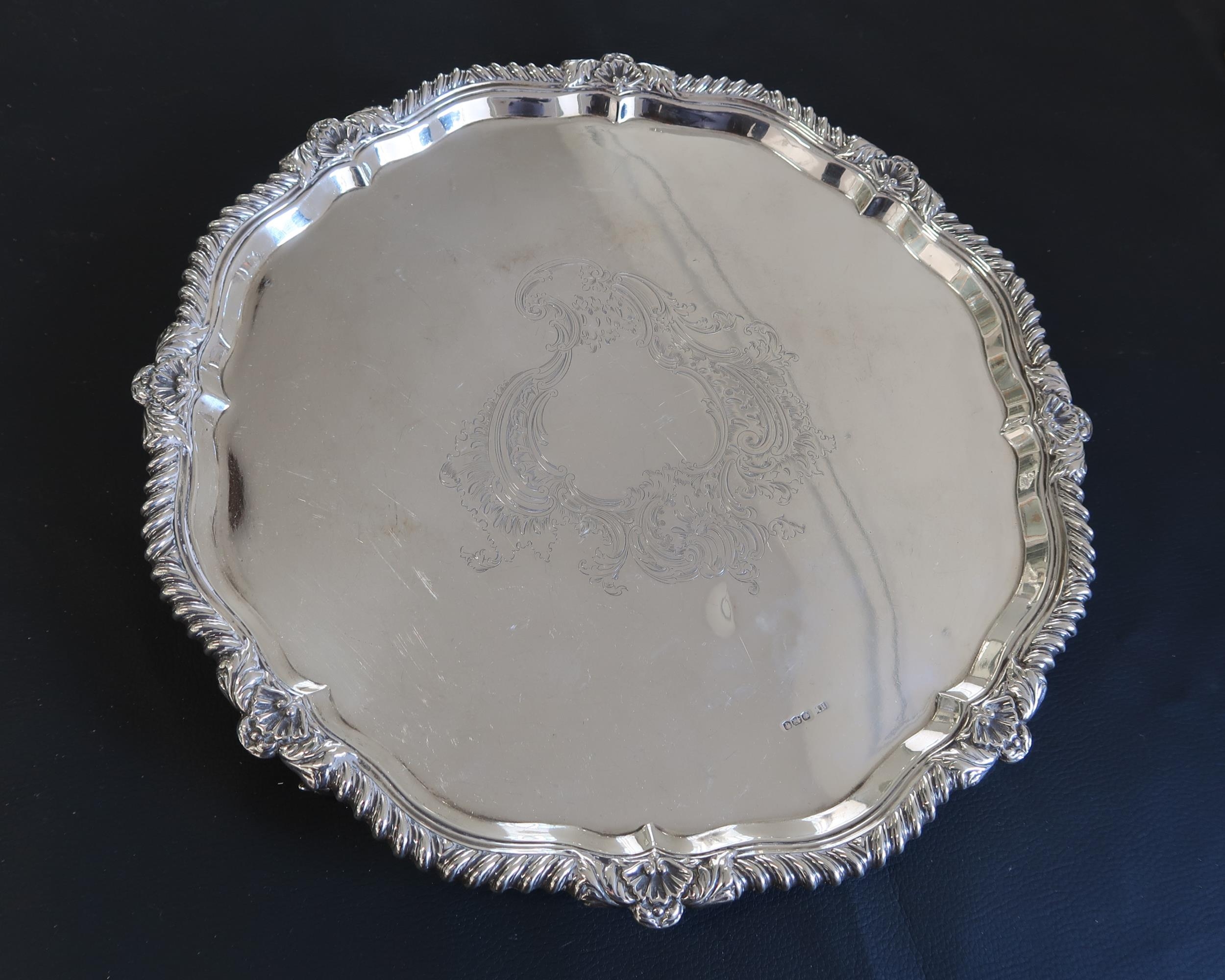 A George V solid silver salver with scalloped gadrooned rim, and ...