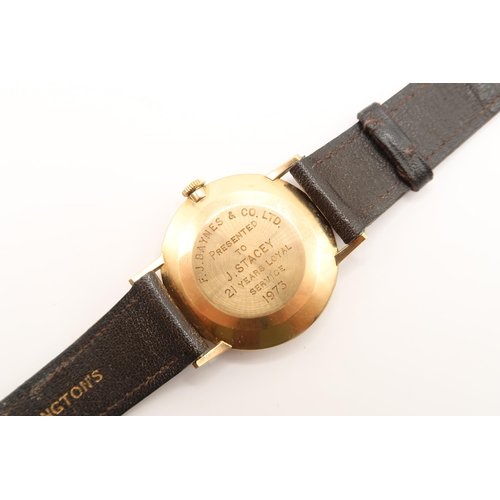 A 9ct 'Bravingtons' Watch featuring a silver sunburst dial, with gold ...