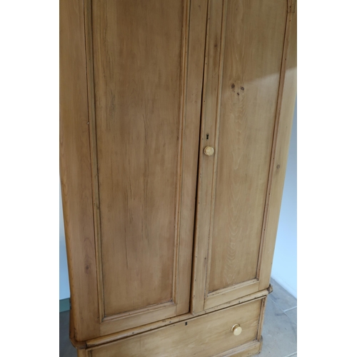 A 19th century tall pine double wardrobe with a base drawer - Width ...