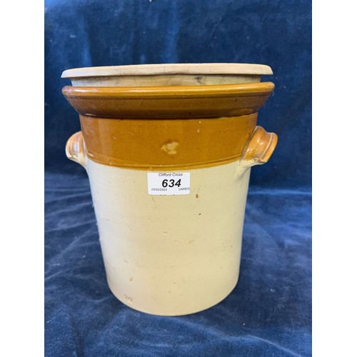 A 2-tone stoneware pot having 2 applied handles and a hand made wooden lid.