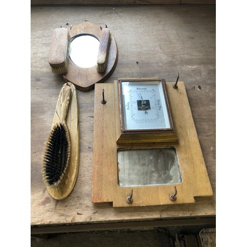 A vintage clothes brush set with mirrored hanger, a clothes brush and ...
