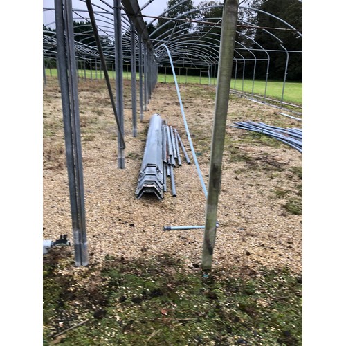A 5 span galvanised pole and timber polytunnel with drainage guttering ...