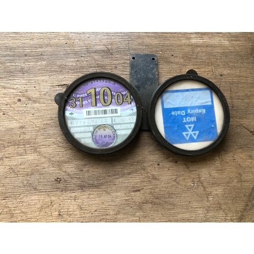 A vintage double vehicle registration/MOT display holder