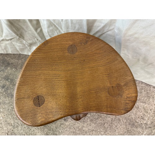 An solid oak 3-legged stool by Robert 'Mouseman' Thompson with the ...