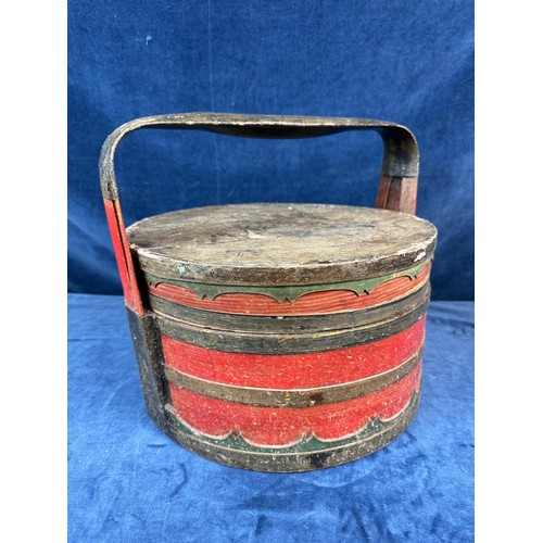 A vintage Chinese picnic basket painted red and black.