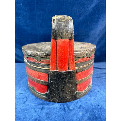 A vintage Chinese picnic basket painted red and black.