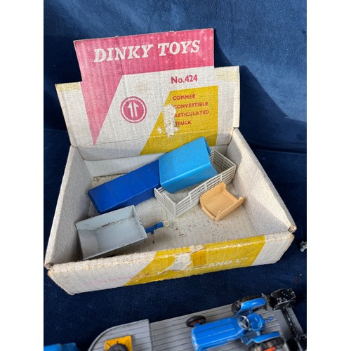 A Dinky toys cardboard box containing; a Corgi toys bedford tractor ...
