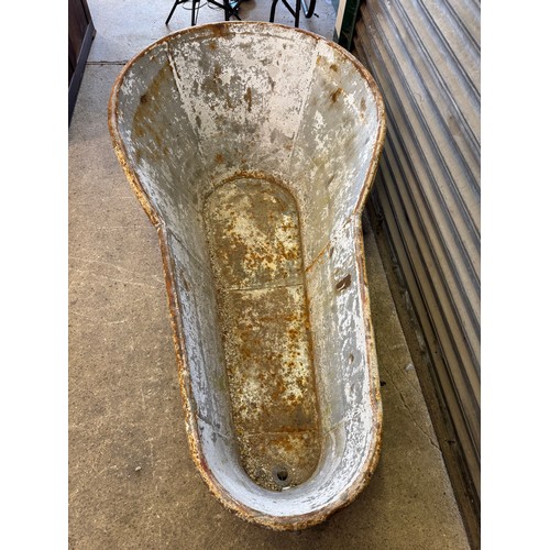 A large vintage tin bath with one end being a wider width.