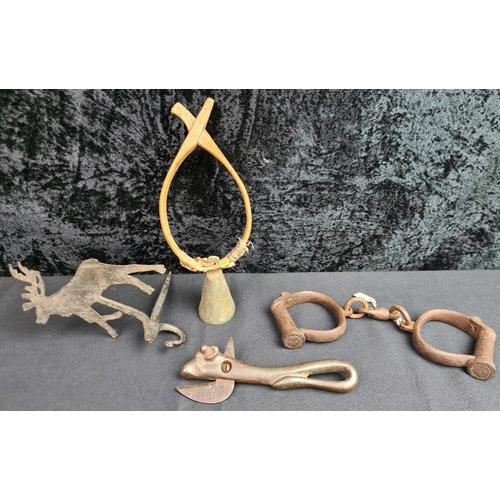 Eclectic assortment of items, including vintage metal handcuffs, cow ...