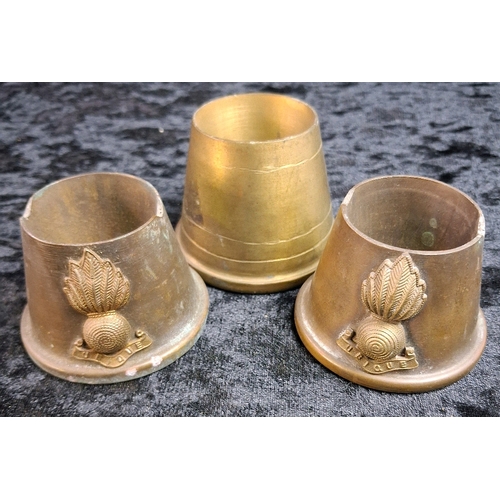 Trench art shell fuse covers turned in to Royal Artillery egg cups.