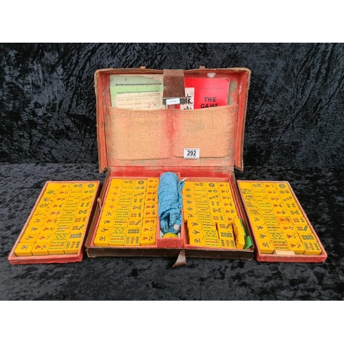 A vintage boxed mahjong set in an old leather case with fitted felt trays.
