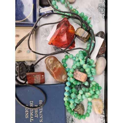 Collection of semi precious stones including a sample box, gold plated ...
