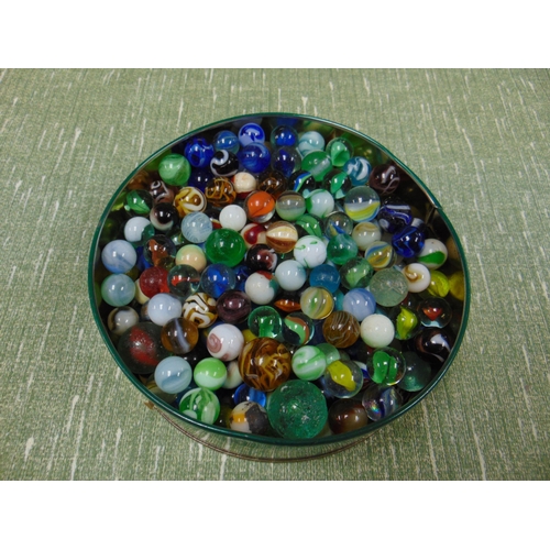 Tin of marbles.