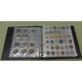 An album containing a collection of foreign coins.