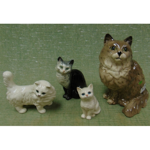 Four Beswick cats.
