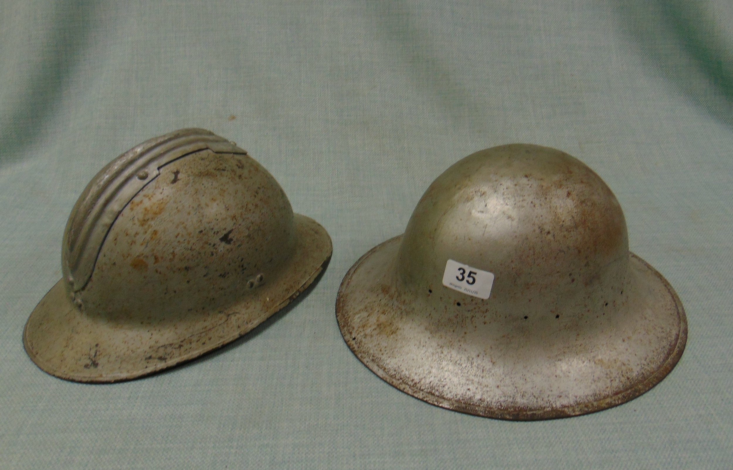 Two tin helmets.