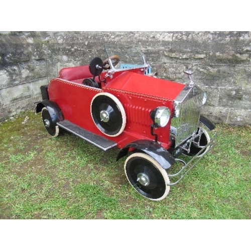 A red rotary pedal car, in the style of Rolls Royce “Brooklands” 1926 ...